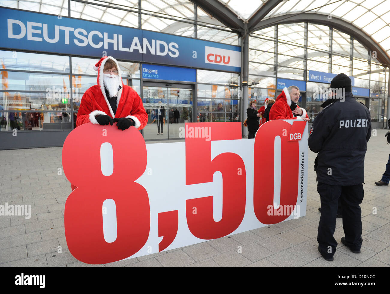 A member of the DGB, the Federation of German Trade Unions, stands with ...