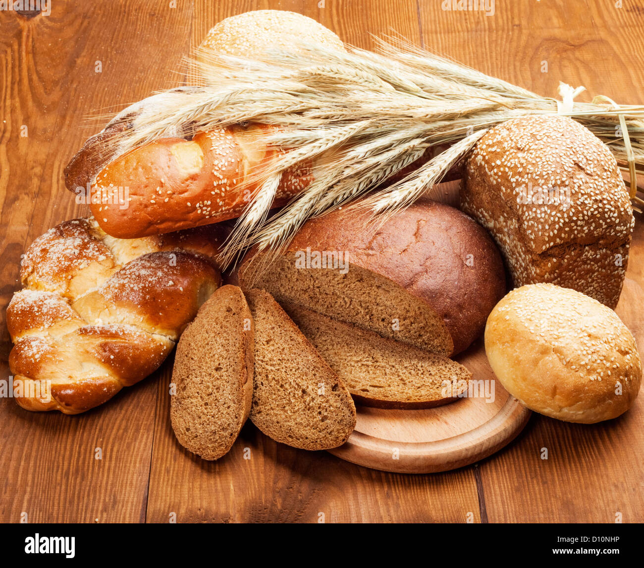 assortment of baked bread on wood table Stock Photo - Alamy
