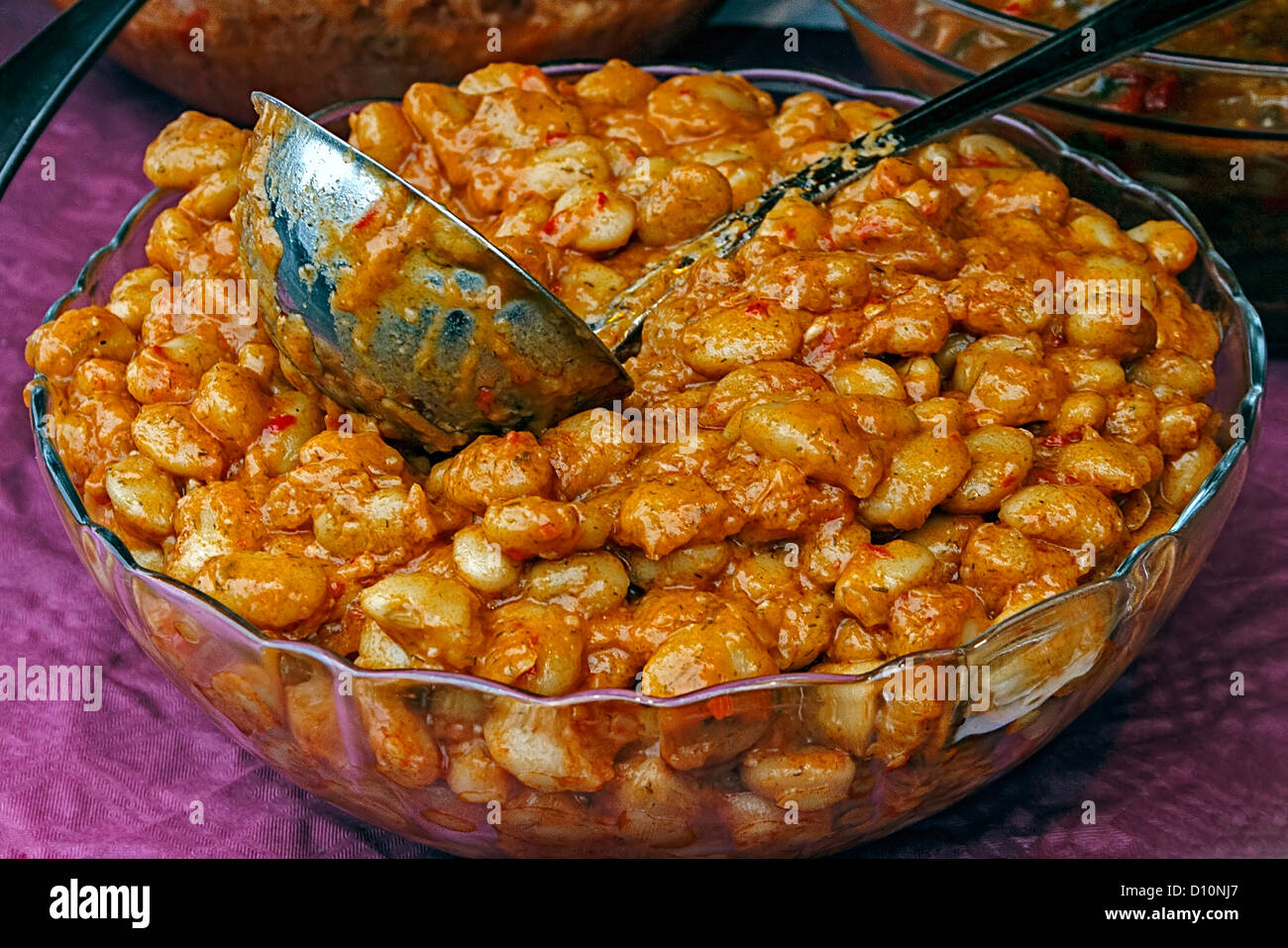 Bean dish placed in a glass bowl with a ladle Stock Photo - Alamy