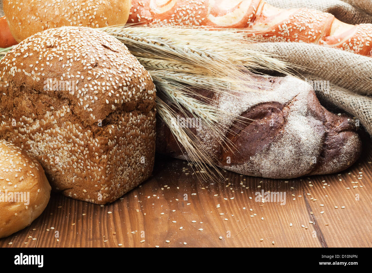assortment of baked bread on wood table Stock Photo - Alamy