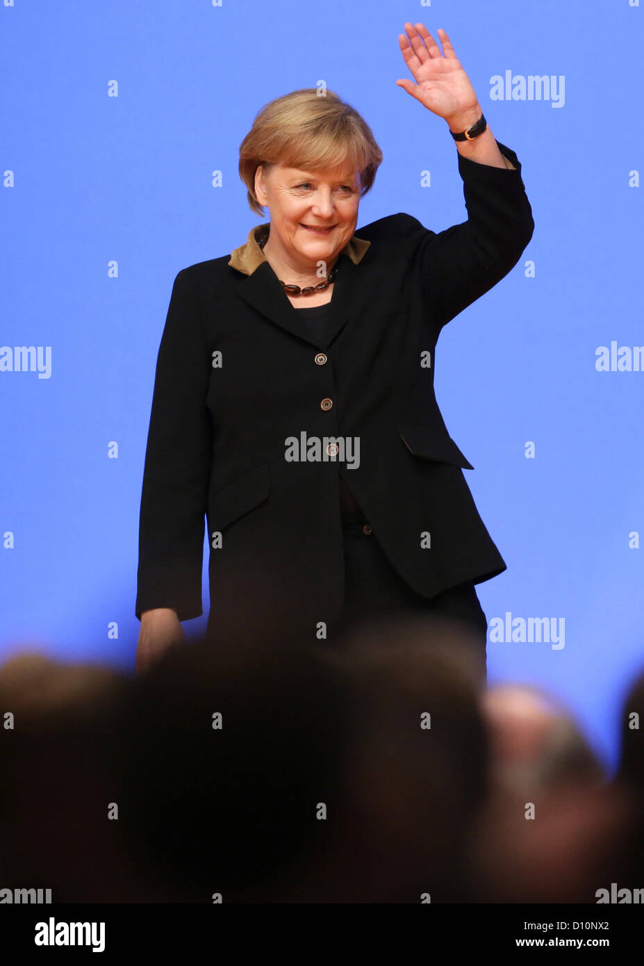 German Chancellor Angela Merkel stands after delivering her speech ...