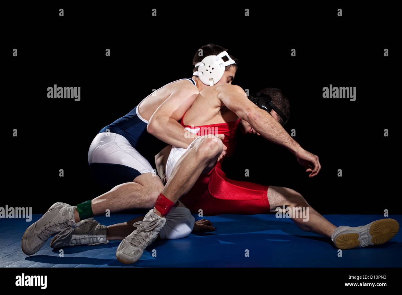Wrestling action. Studio shot over black Stock Photo - Alamy