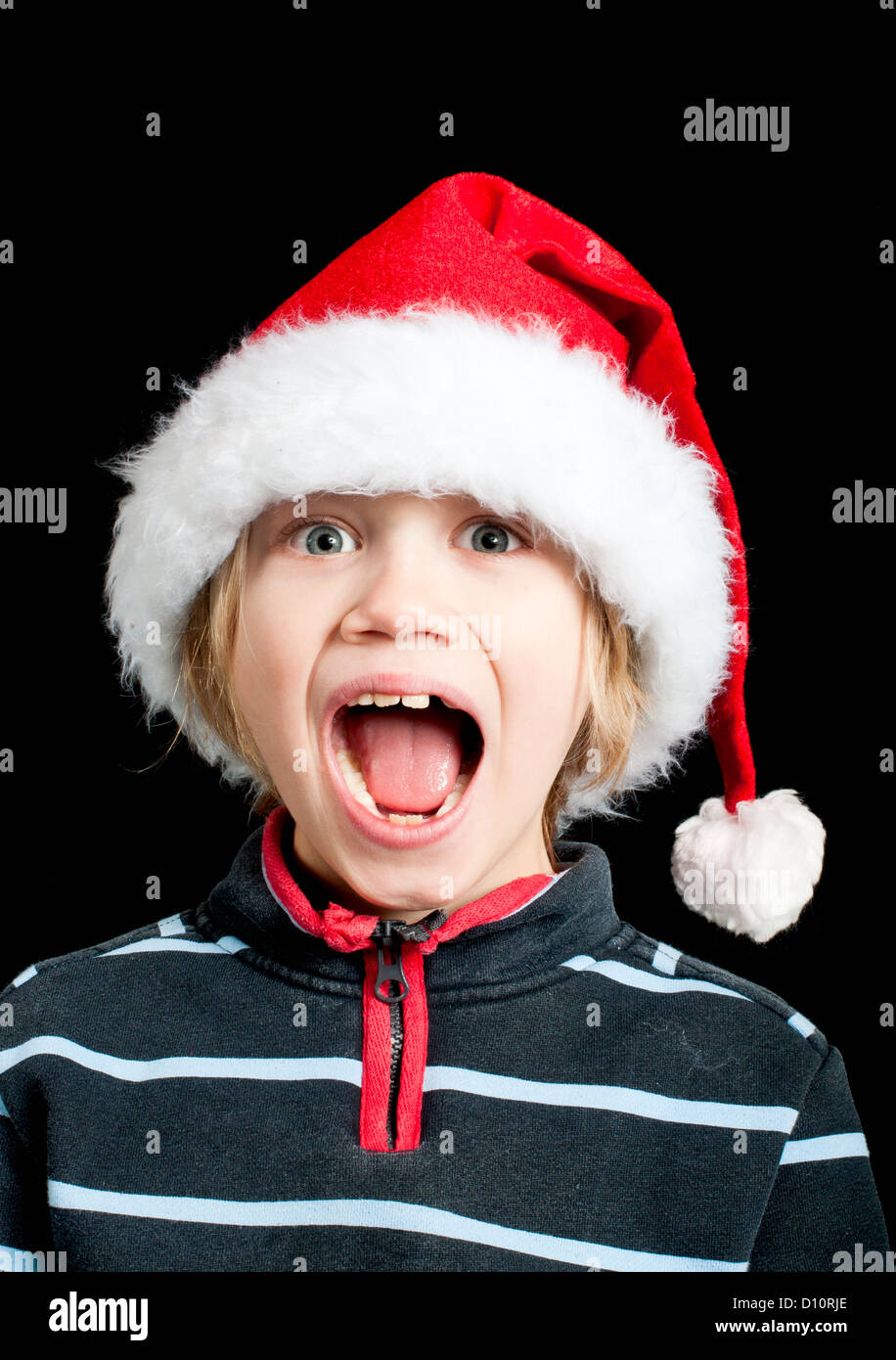 A happy boy wearing a Santa hat Stock Photo - Alamy