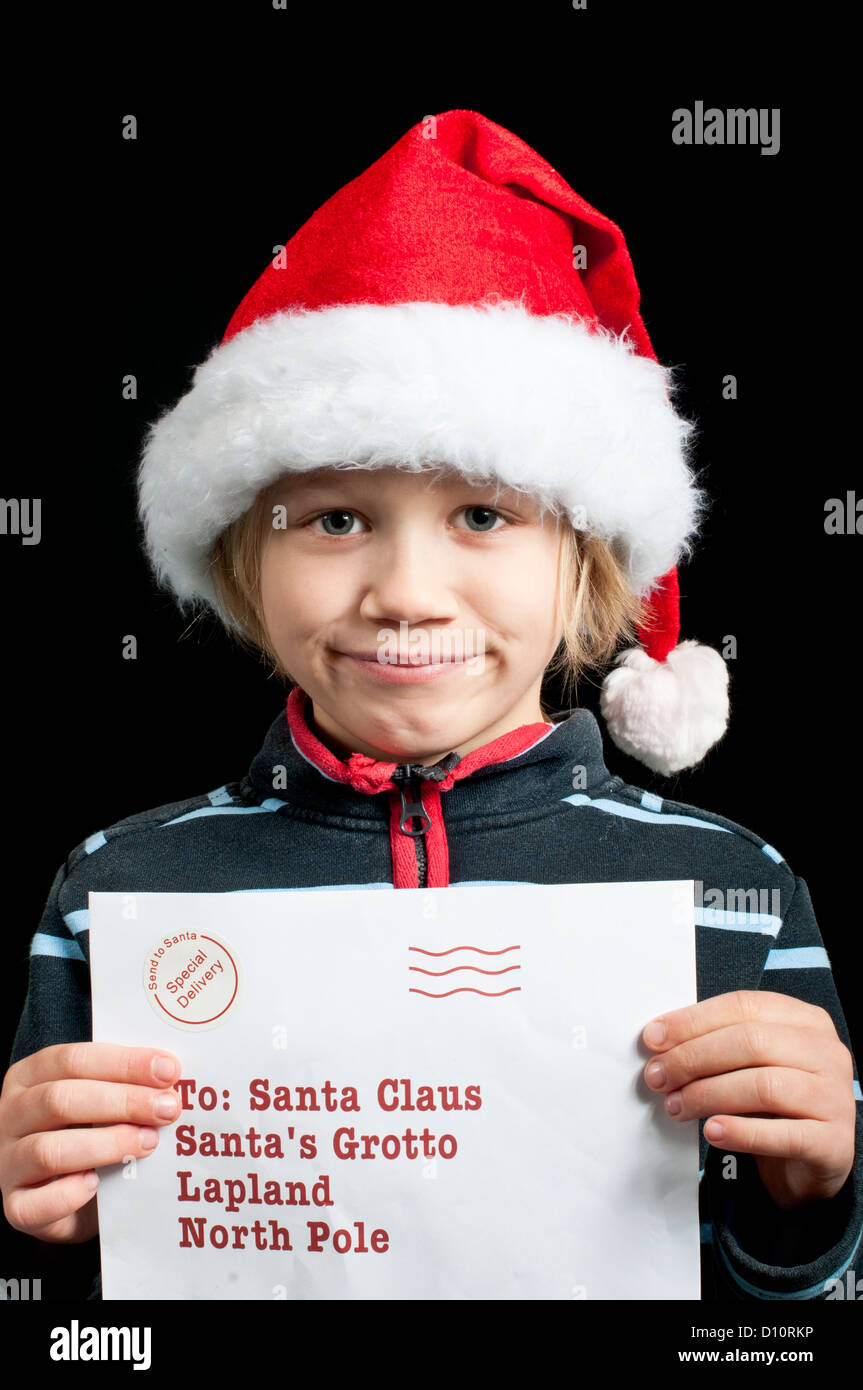 A little boy holding his letter for Santa Claus Stock Photo - Alamy