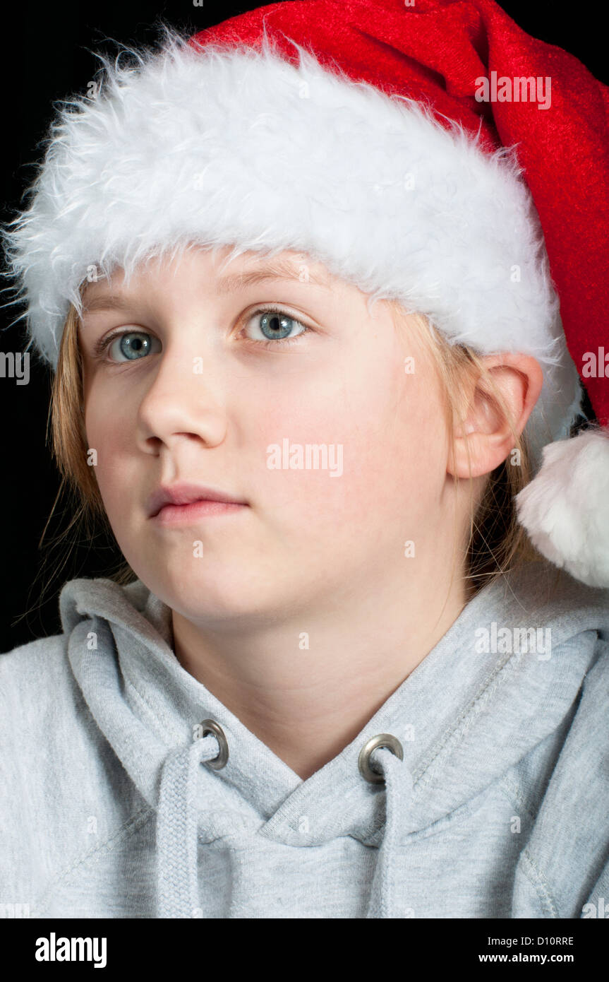 Girl wearing a Santa hat Stock Photo - Alamy