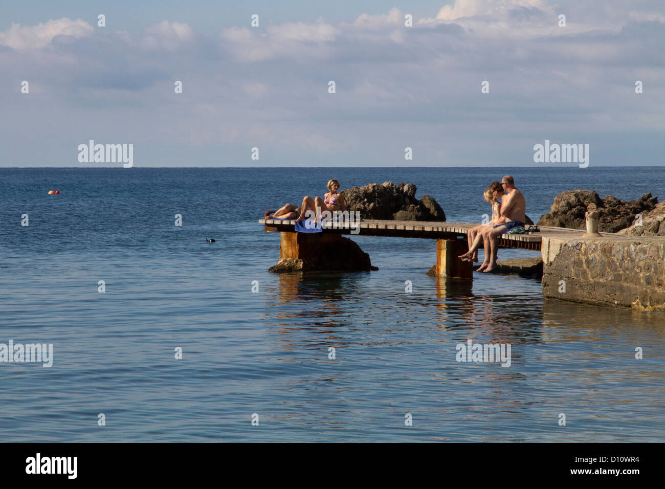 People tourists relaxing and sunbathing on pier oversea sea Mallorca ...