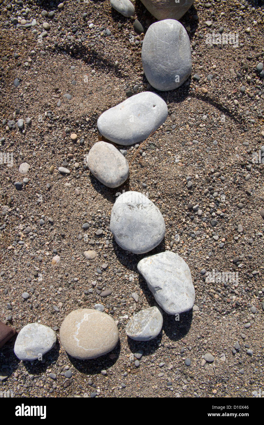drawings with stones on sand Stock Photo - Alamy