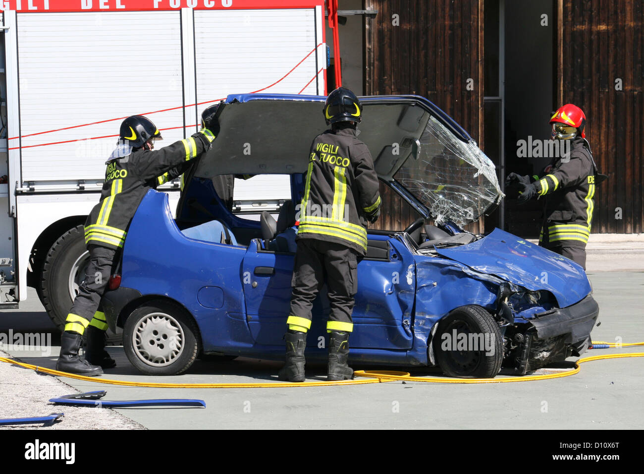 firefighters in action for free from a blue car, injured in a car ...