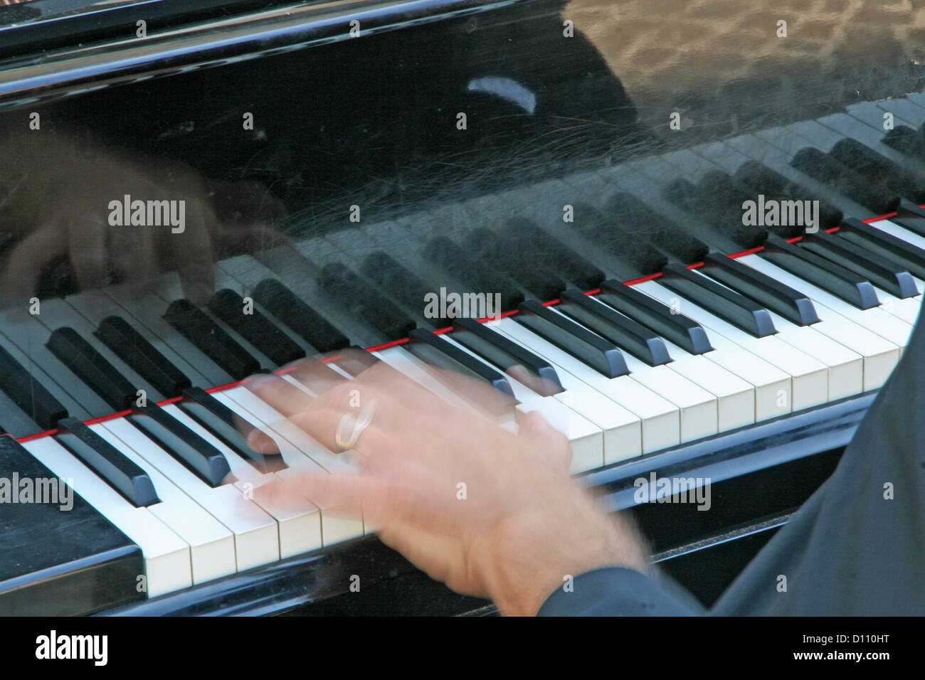 moving hand that plays the white and black keys on piano Stock Photo ...