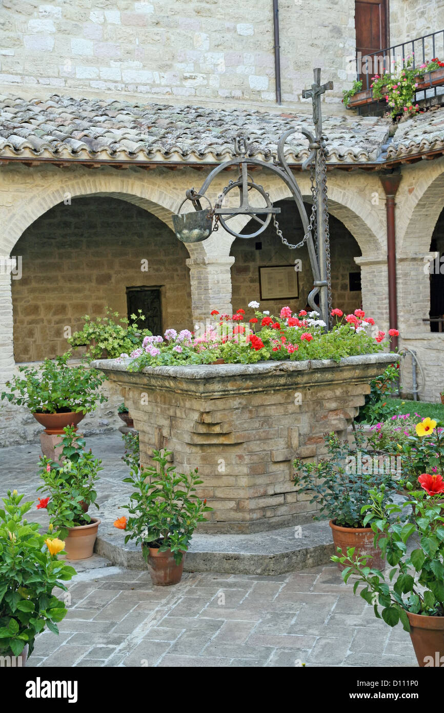 ancient medieval pit for water harvesting with flower pots in a convent ...