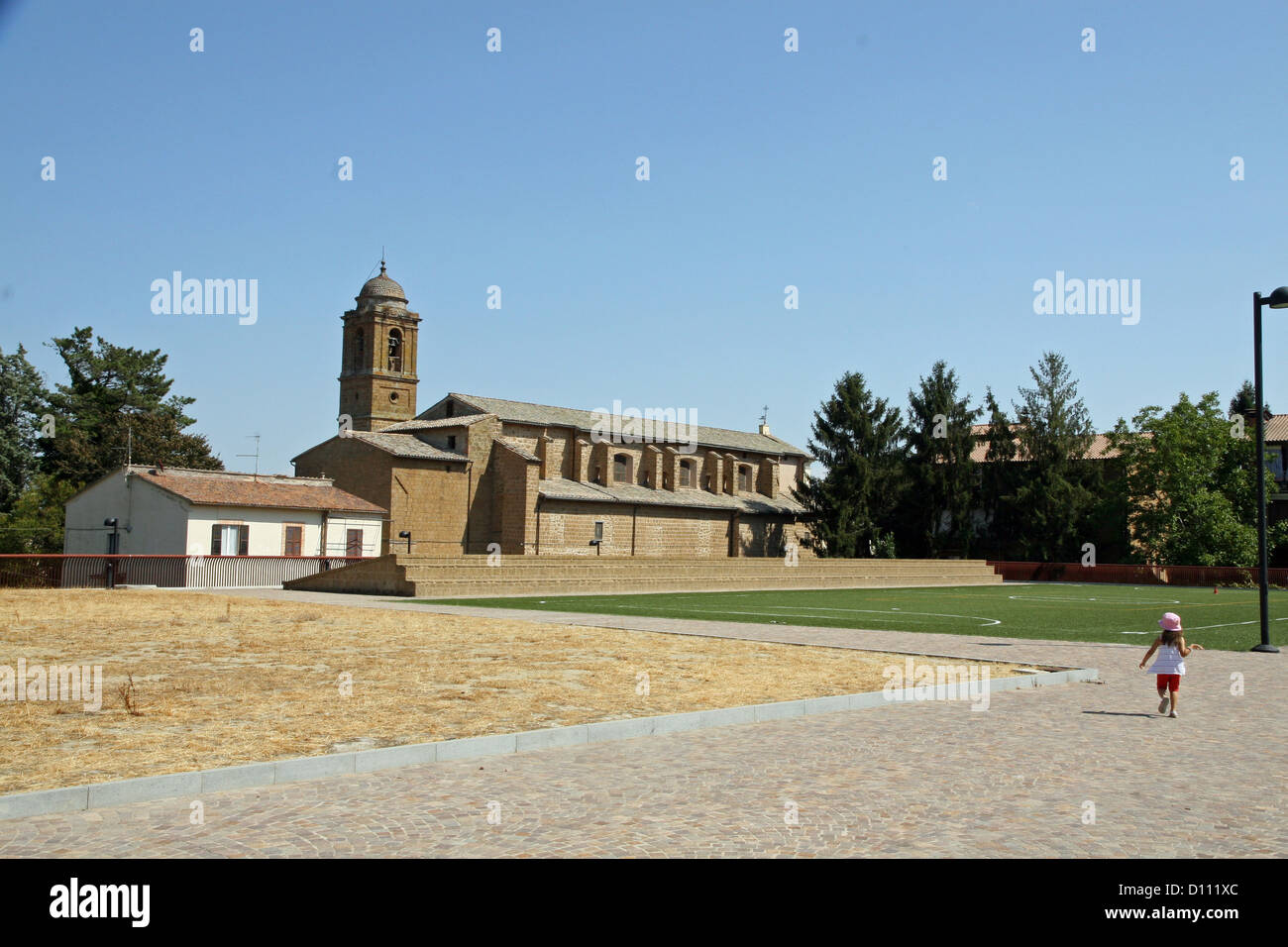 Church is made of Tuff with near a soccer field and a little girl Stock ...