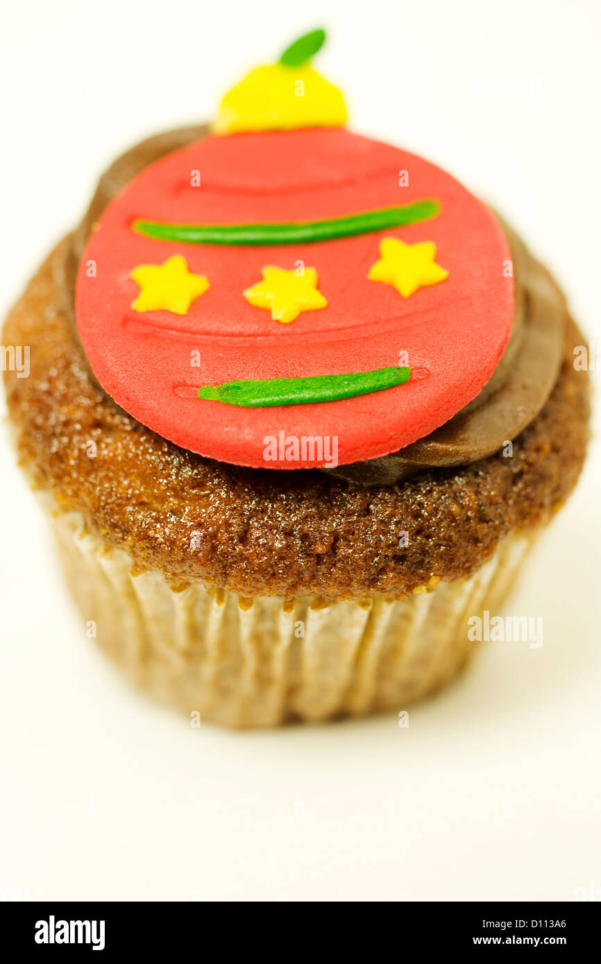 Christmas bauble cupcake. The banana cup cake is topped with a red ...