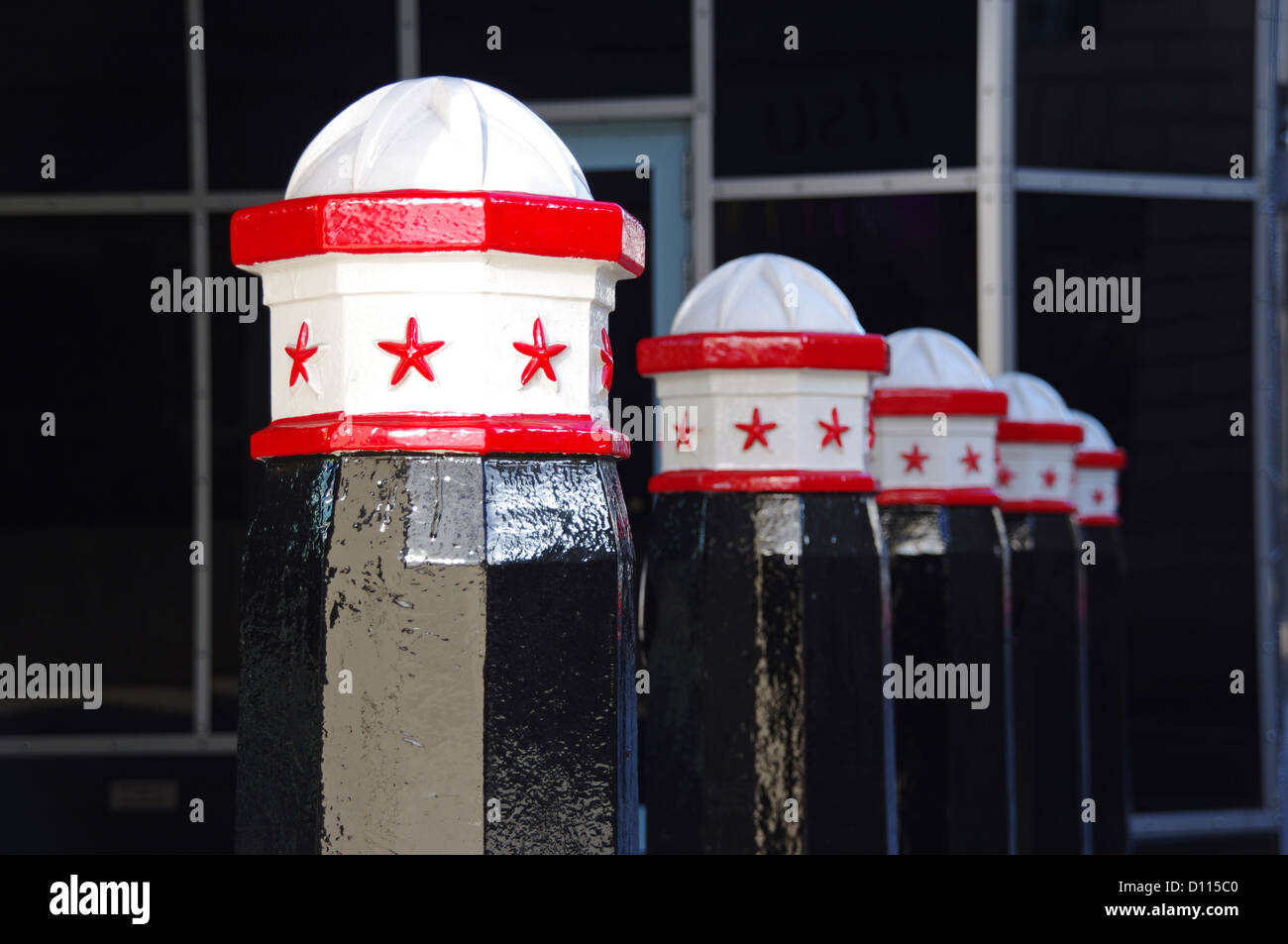 Red stars on white paint bollard post in London Stock Photo - Alamy