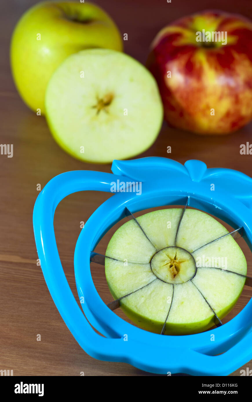 Blue apple slicer. Yellow and red apples Stock Photo - Alamy
