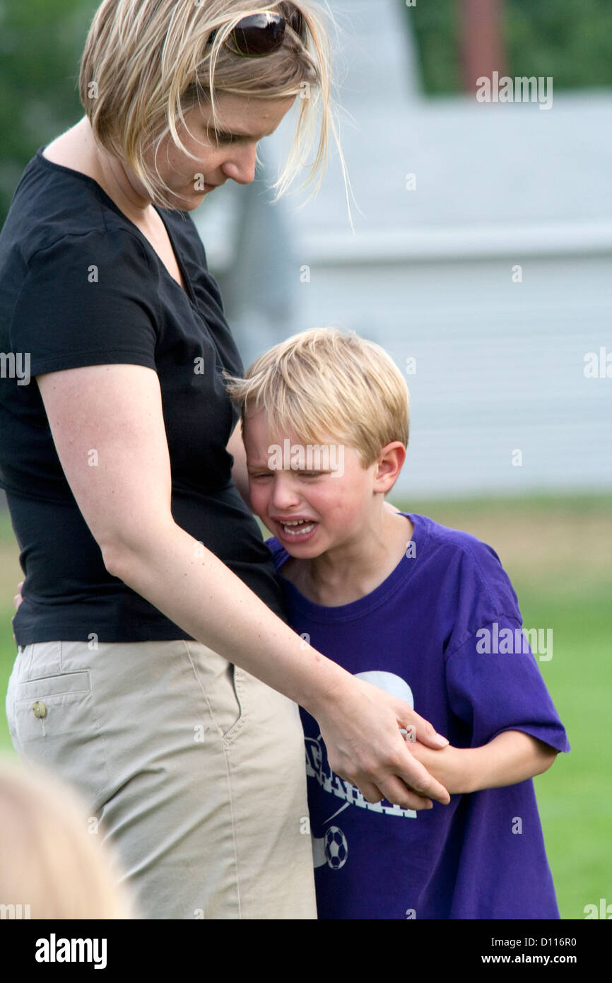 Boy being comforted mother after hi-res stock photography and images ...