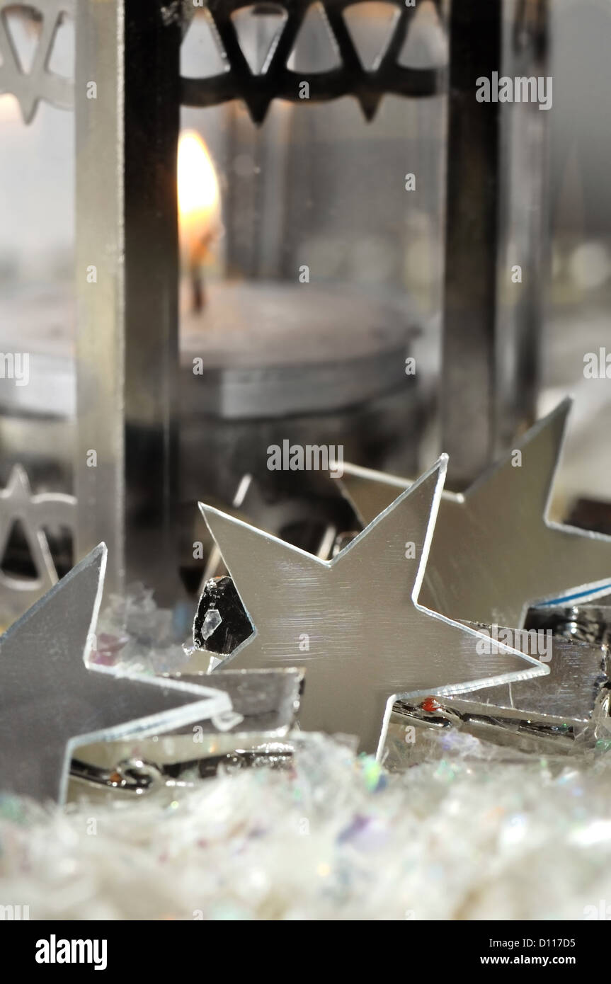 silver stars against a lit candle holder Stock Photo - Alamy