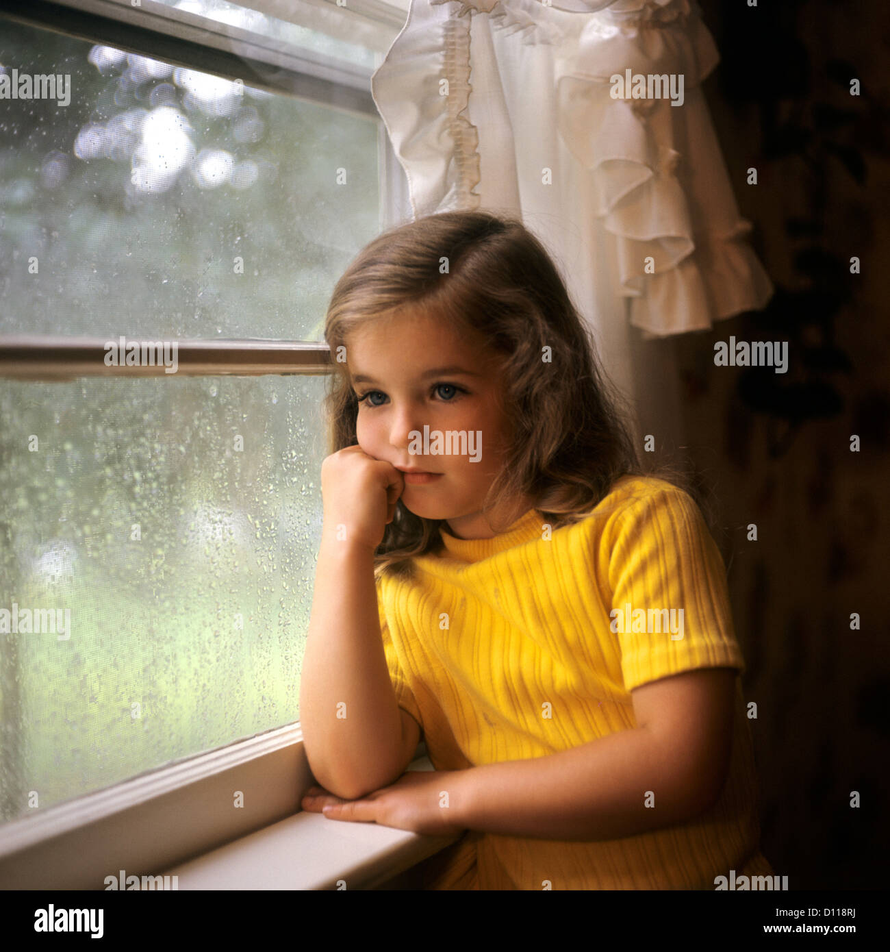 1970s YOUNG GIRL SAD PENSIVE THINKING RAIN ON WINDOW PANE Stock Photo ...
