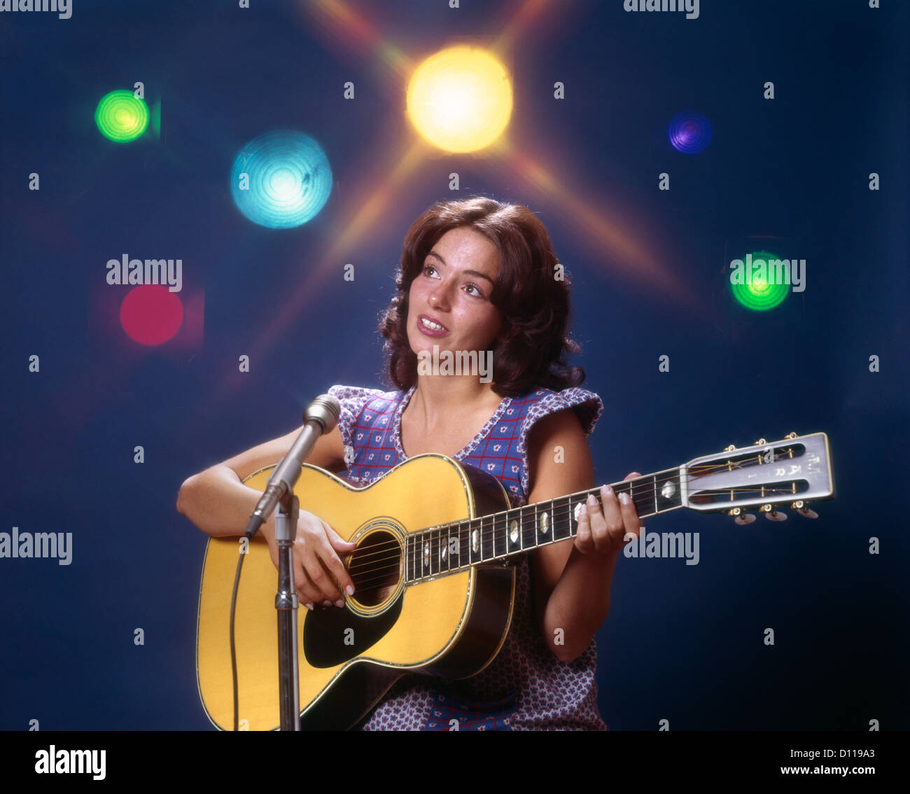1970s WOMAN GIRL PERFORMER PLAYING GUITAR SINGING MICROPHONE STAGE ...