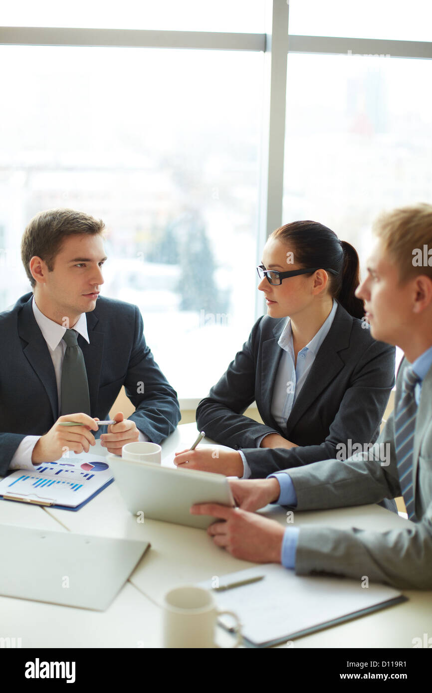 Vertical image smart employees discussing hi-res stock photography and ...