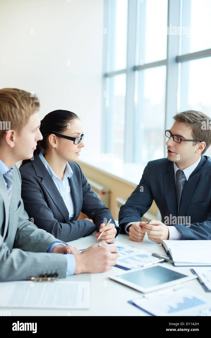 Image of three business people negotiating at meeting Stock Photo - Alamy