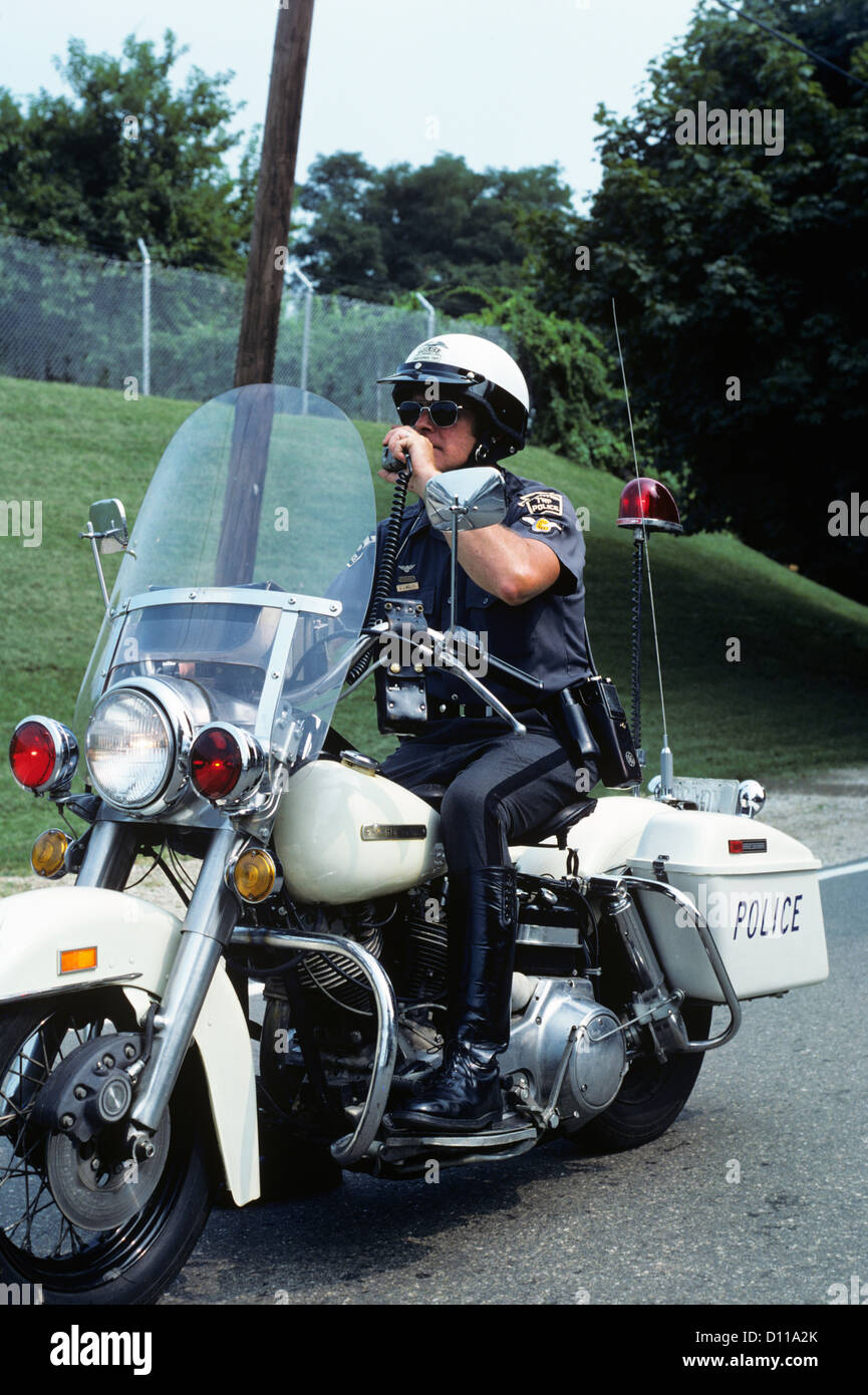 1970s MOTORCYCLE POLICE OFFICER TALKING ON HANDHELD RADIO Stock Photo ...