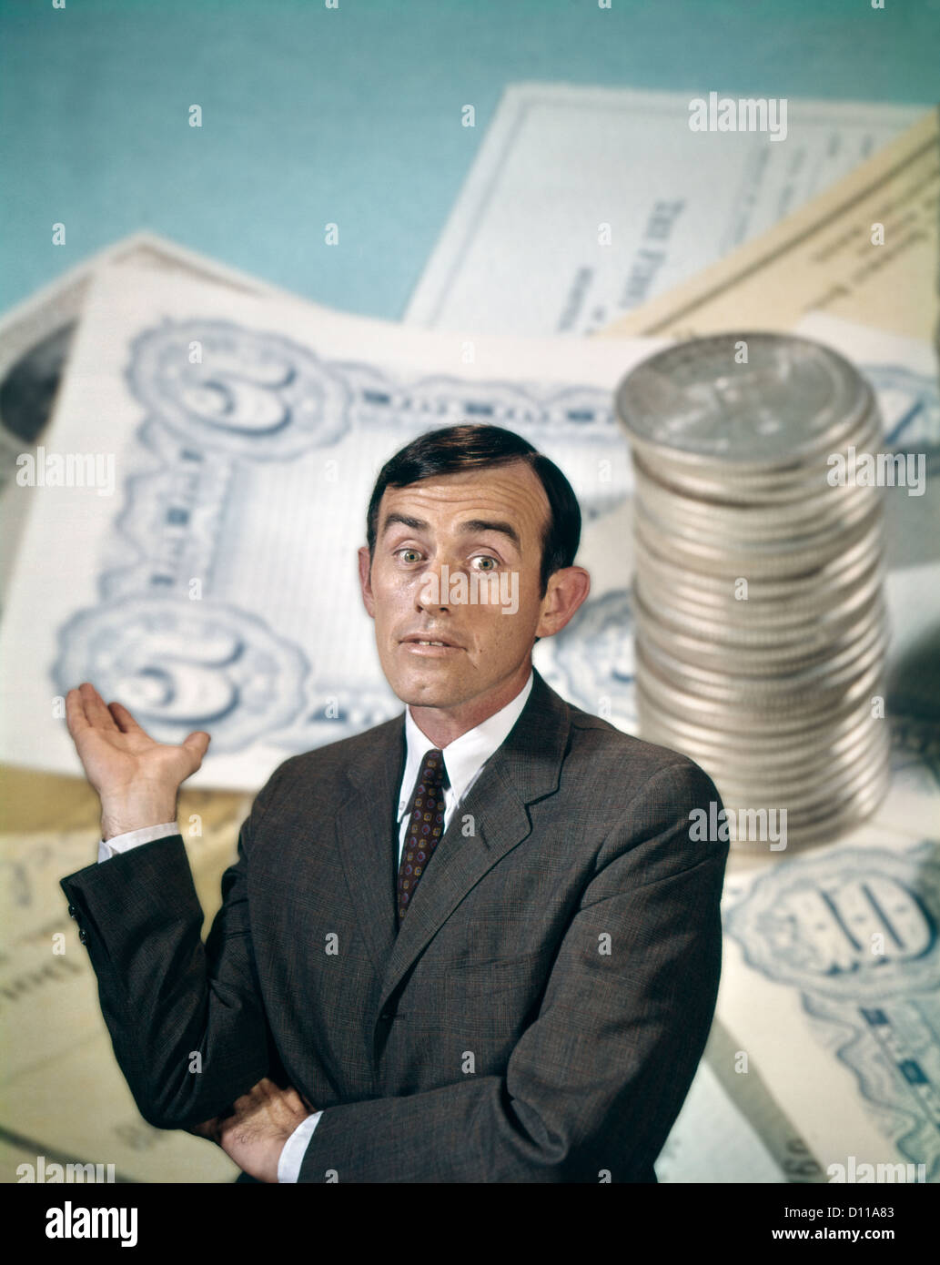 1960s BUSINESSMAN LOOKING AT CAMERA WITH A BACKGROUND OF MONEY CHECKS ...