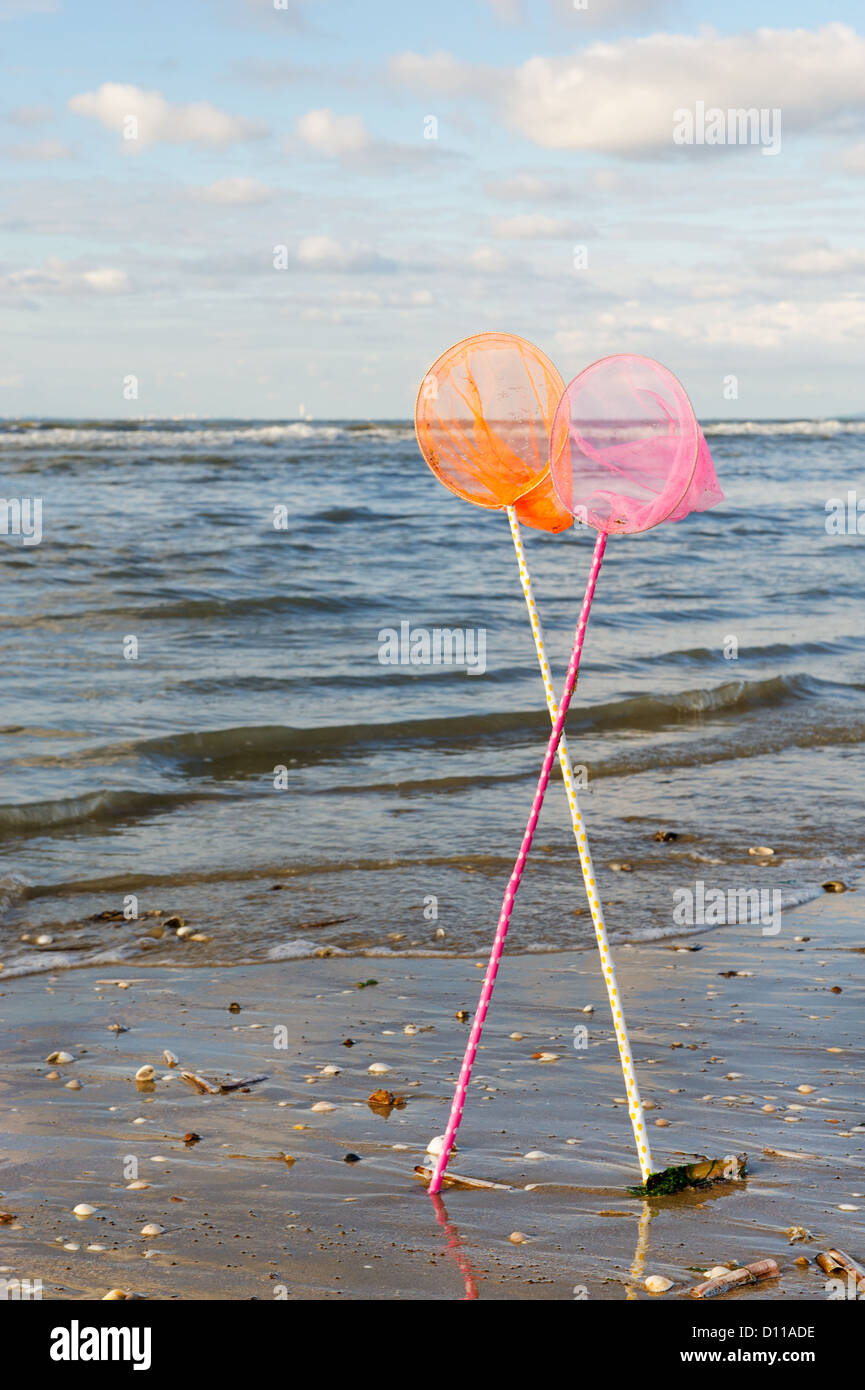 Colorful fishing nets at the beach near the water line Stock Photo - Alamy