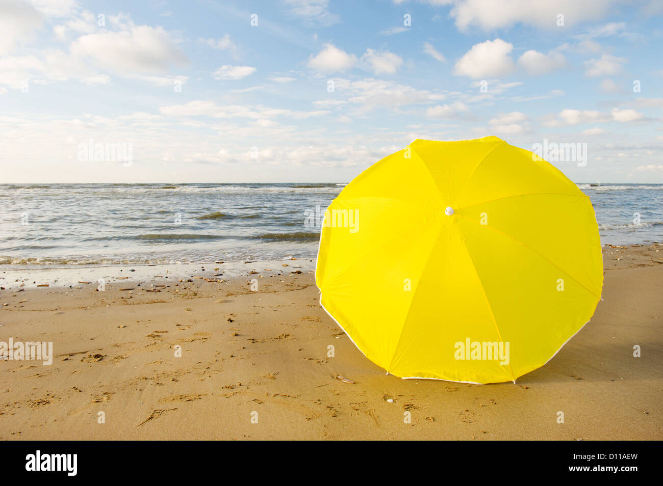 Yellow parasol at the French Normandy beach Stock Photo - Alamy