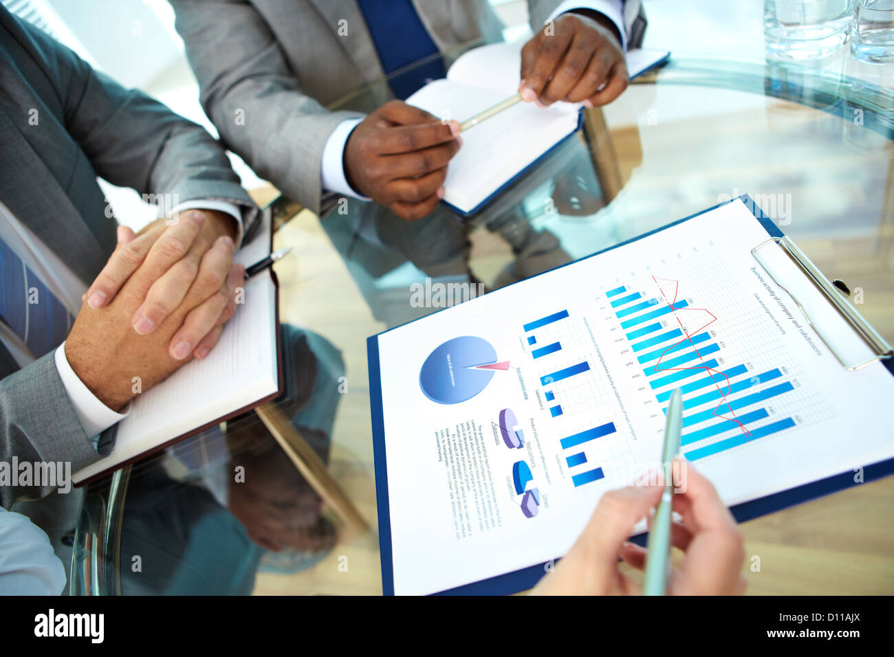 Close-up of human hand with pen pointing at paper while explaining ...