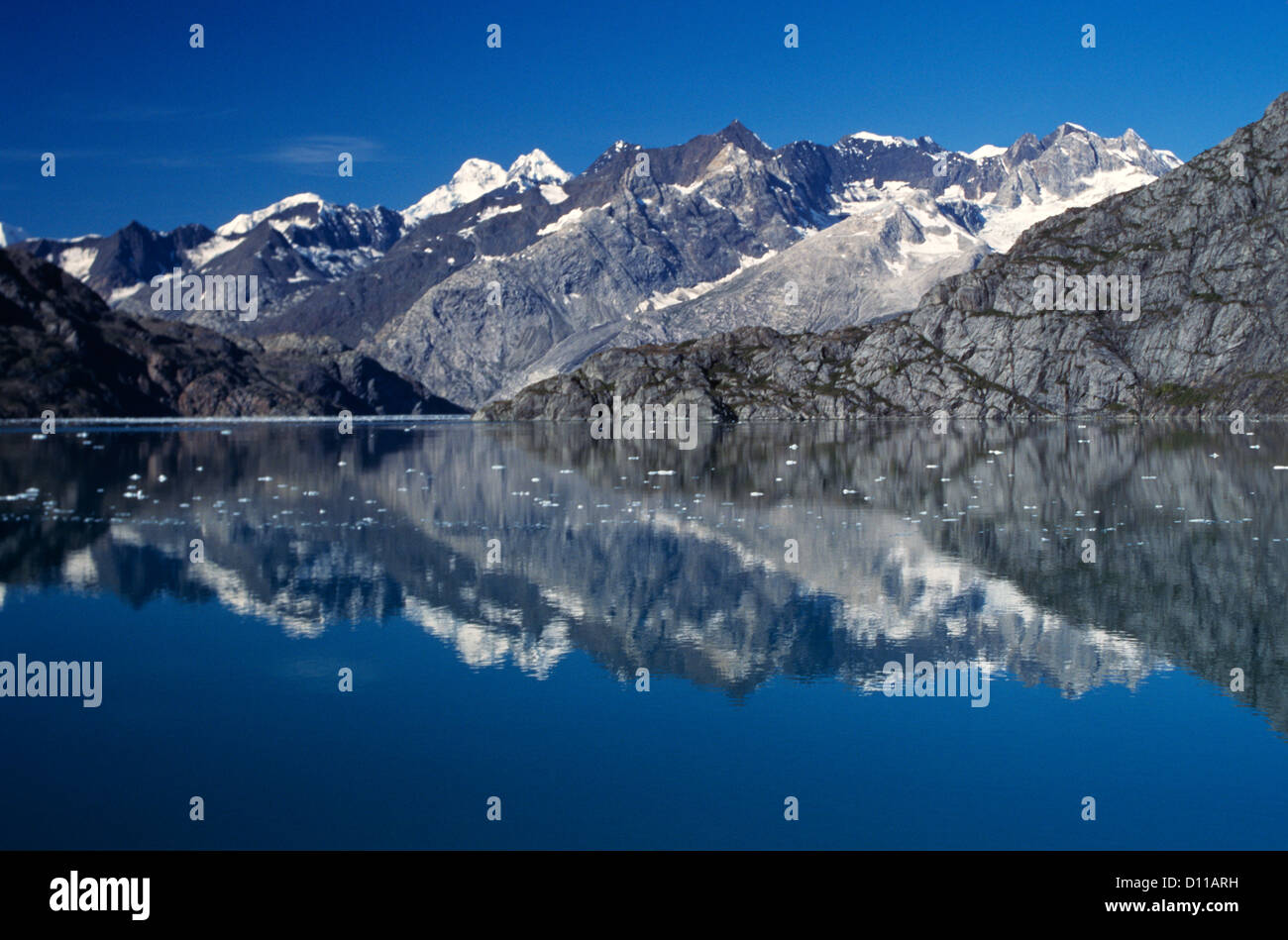 1990s GLACIER BAY MOUNTAINS AND BLUE SKY REFLECTED IN WATER ALASKA USA ...
