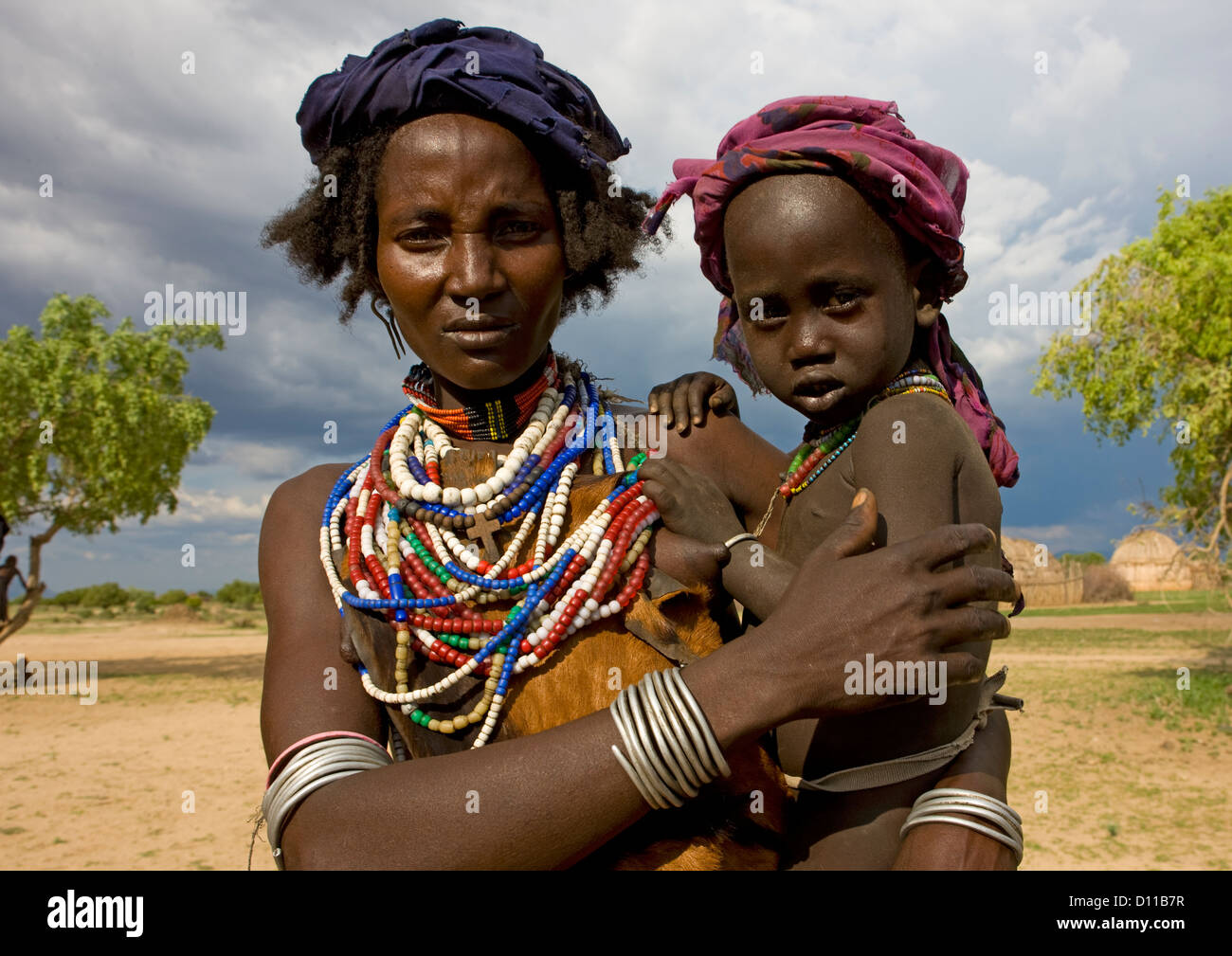Portrait Of An Erbore Tribe Mother With Colourful Necklaces Holding Her ...