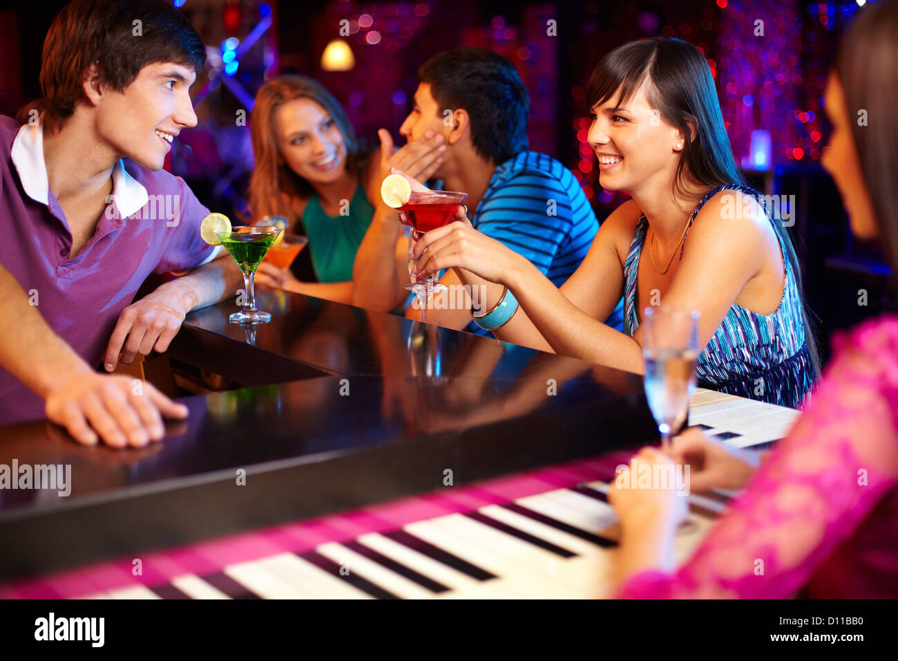 Portrait of joyful friends having party in the bar Stock Photo - Alamy
