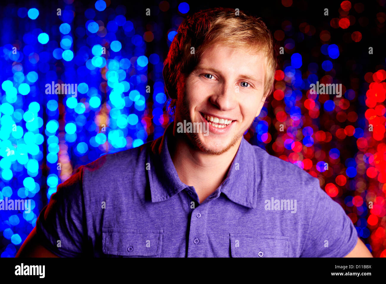 Image of happy guy looking at camera in the night club Stock Photo - Alamy
