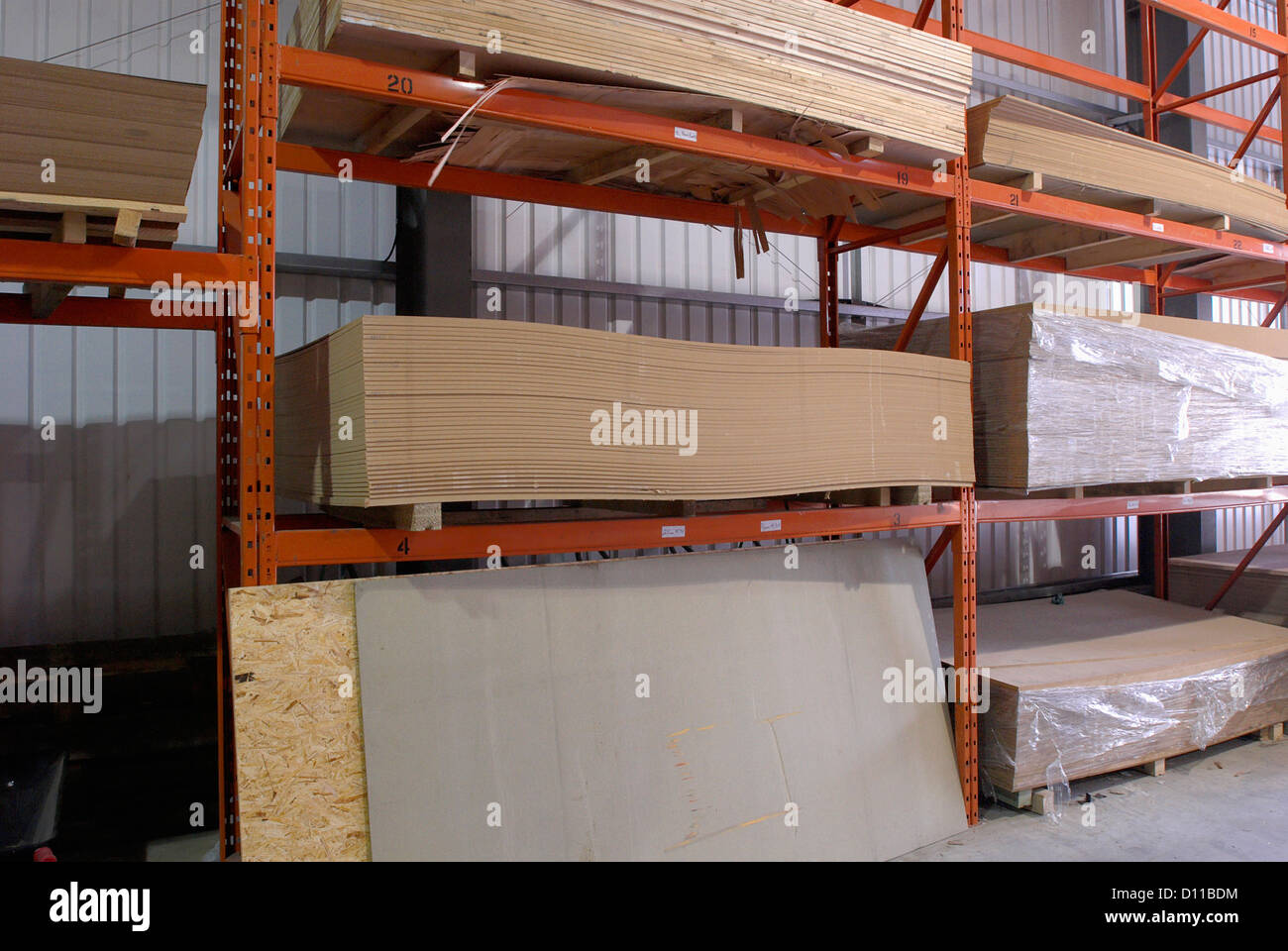 Stacked wood in timber merchant warehouse Stock Photo - Alamy
