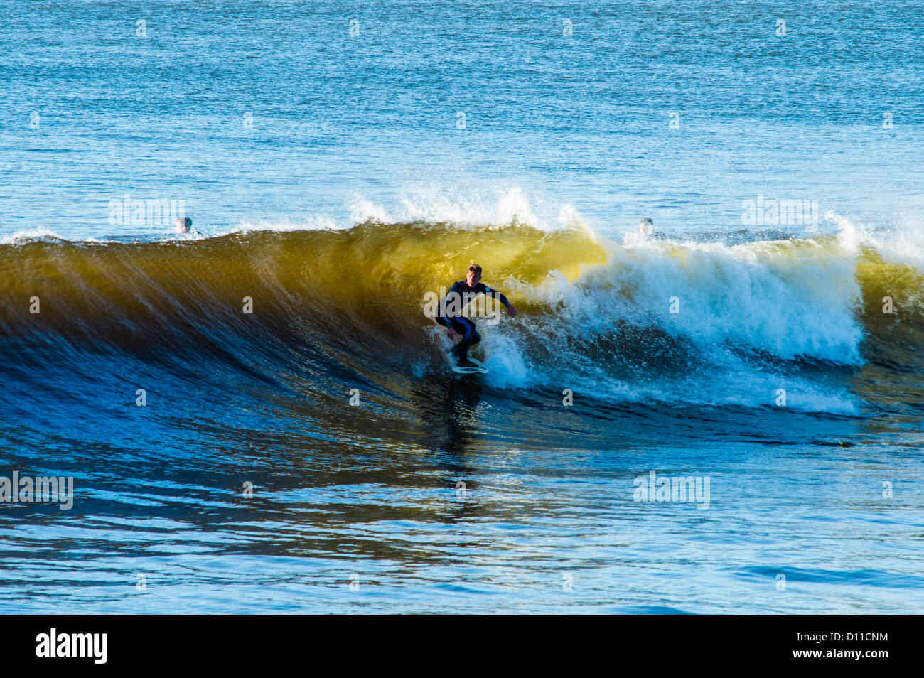 Aberystwyth Wales UK Surfers riding the waves at the mouth of the ...