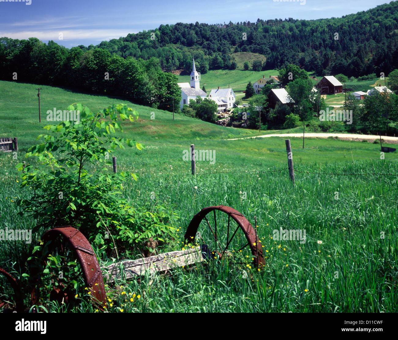 VILLAGE OF EAST CORINTH VT RUSTED FARM EQUIPMENT IN GREEN SUMMER MEADOW ...