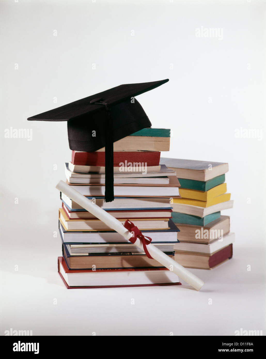 1970s GRADUATION STILL LIFE OF DIPLOMA AND MORTARBOARD ON TOP OF PILE ...