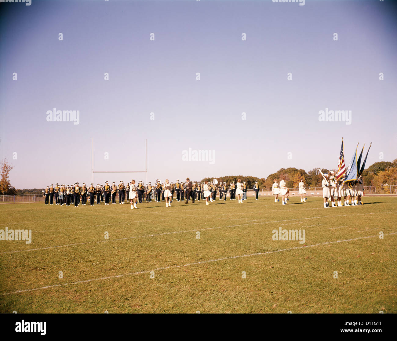 1960s HIGH SCHOOL MARCHING BAND PRACTICING ON FOOTBALL FIELD Stock ...