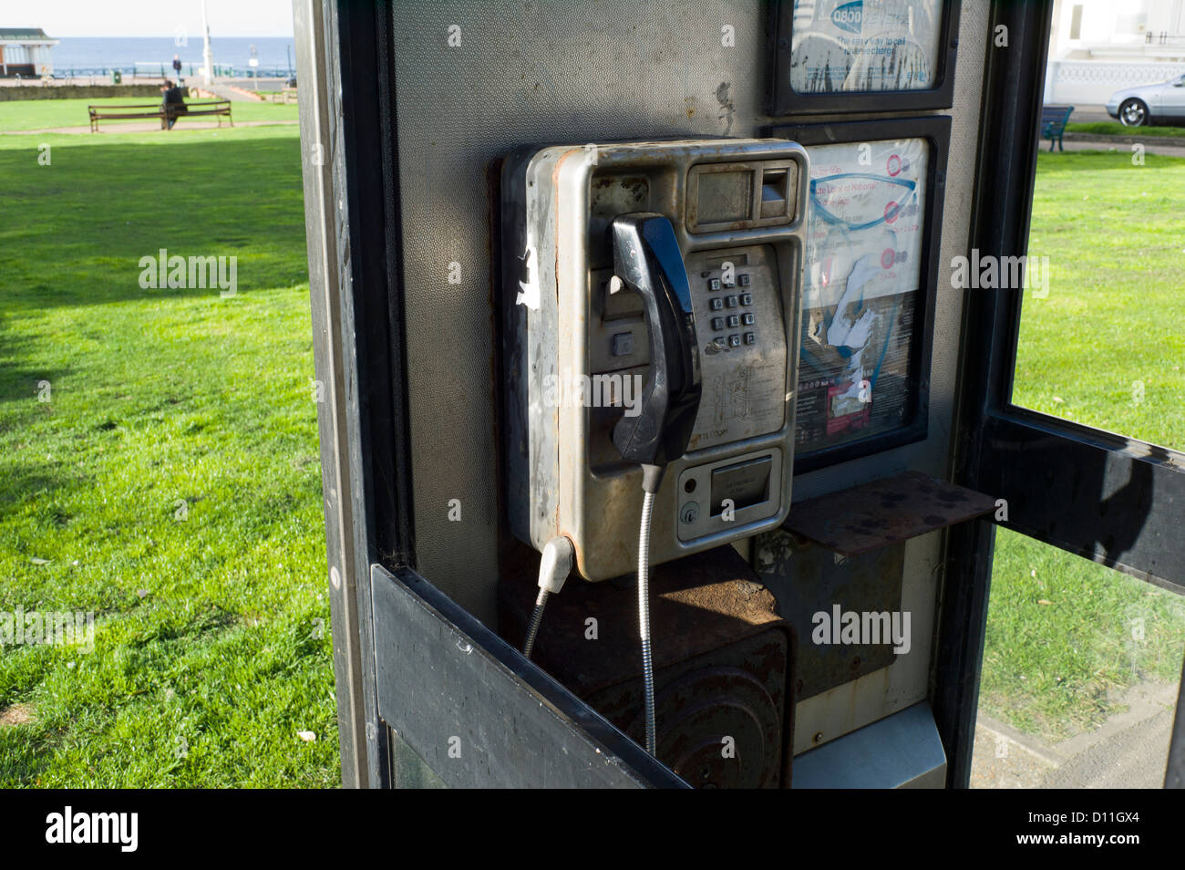 Rusty public telephone in vandalised kiosk Stock Photo - Alamy