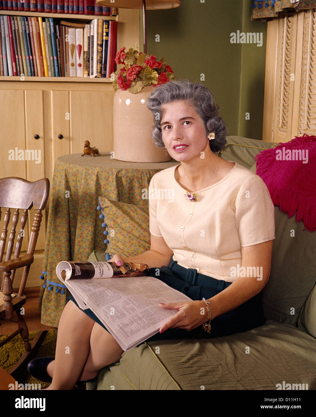 1960s MIDDLE AGED WOMAN READING HOLDING OPEN MAGAZINE SMILING SITTING ...