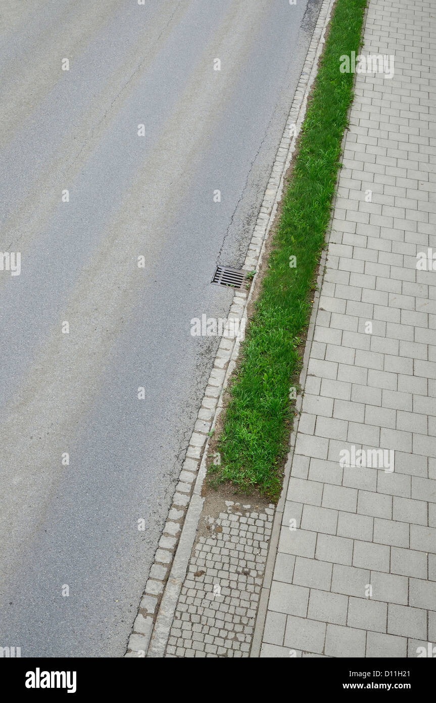 Germany, Bavaria, Grass between street and pavement Stock Photo - Alamy