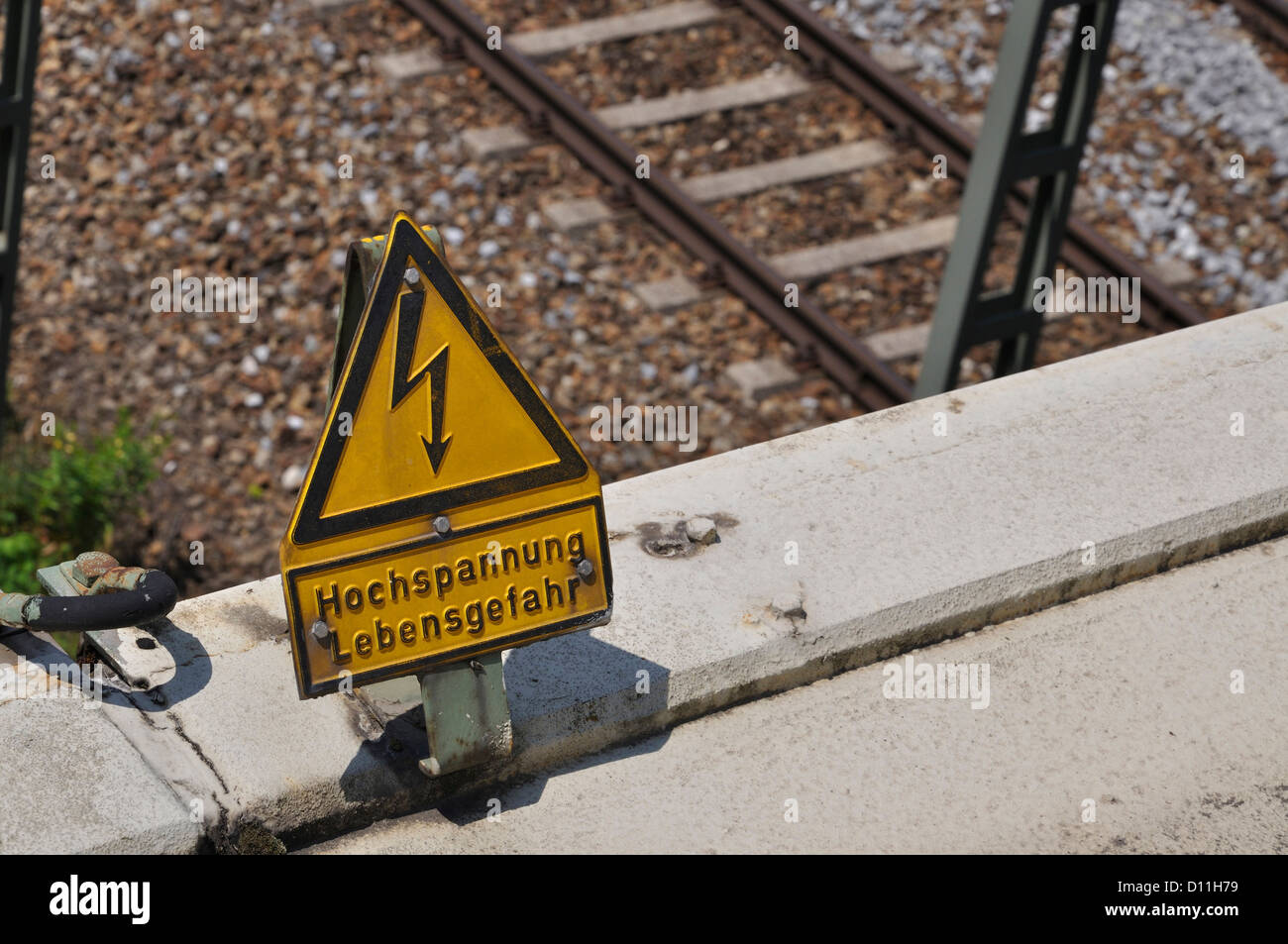 Germany, Bavaria, High voltage sign on railway track Stock Photo - Alamy