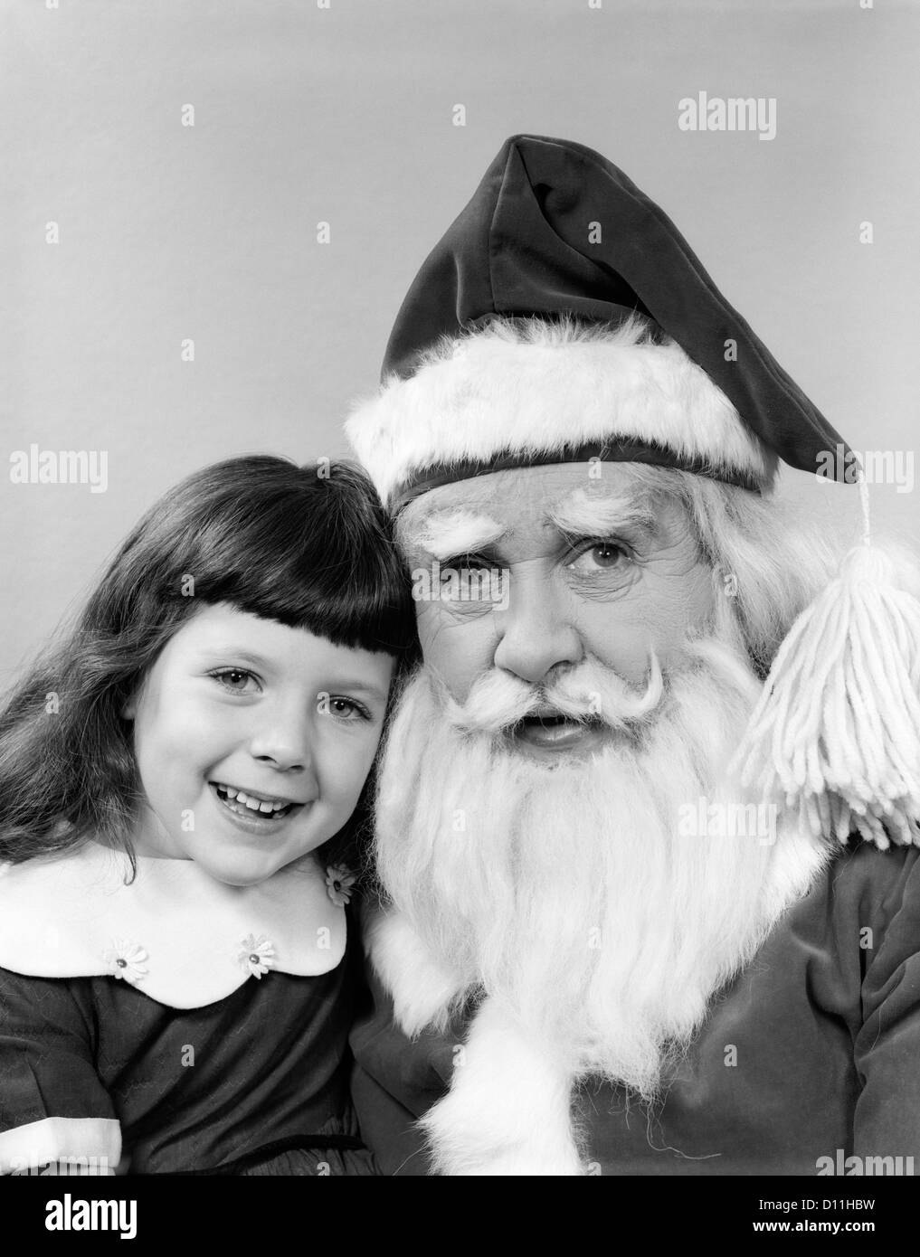 `1950s PORTRAIT SANTA CLAUS WITH SMILING GIRL LOOKING AT CAMERA Stock ...