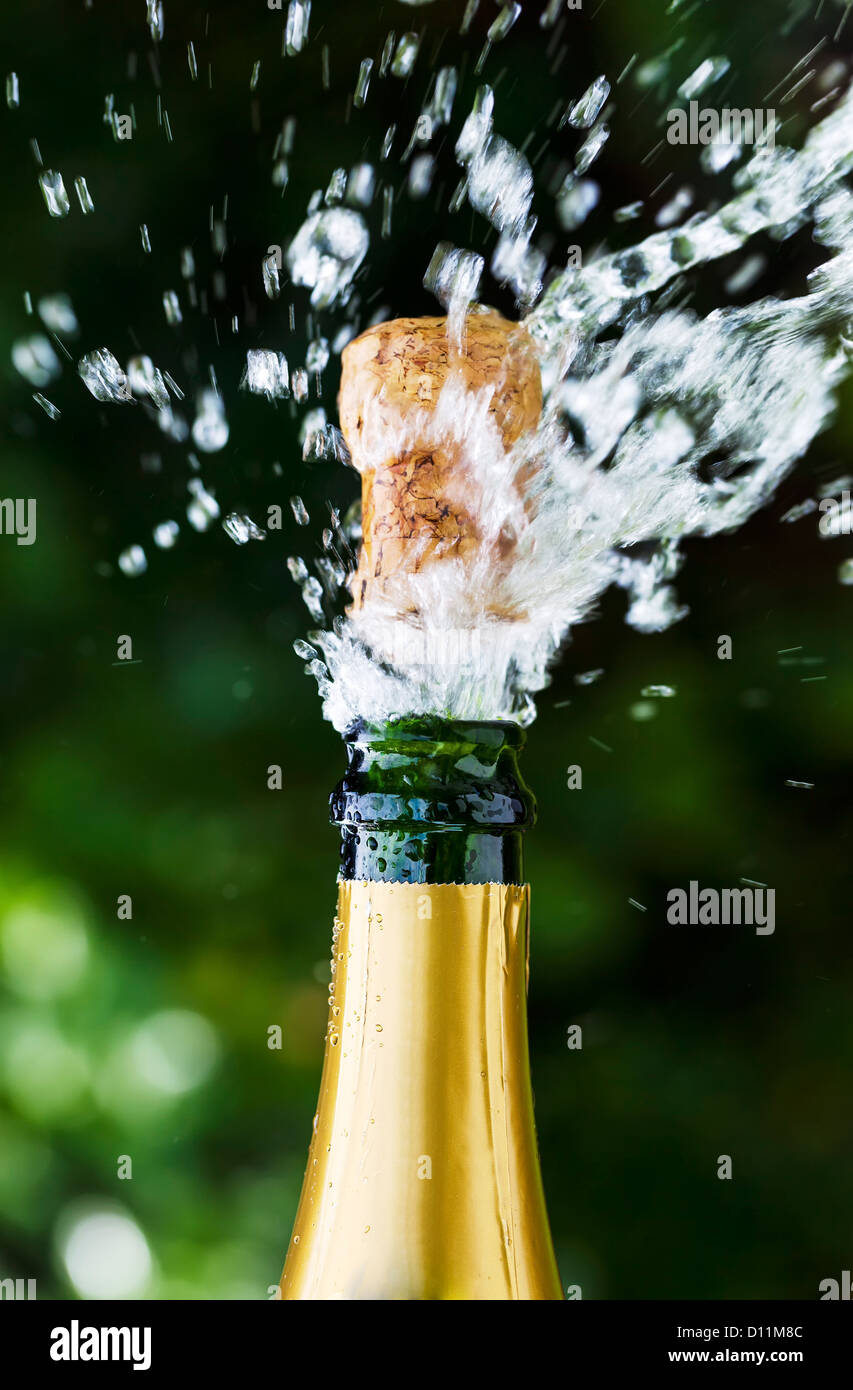 Opened champagne bottle with flying cork Stock Photo - Alamy