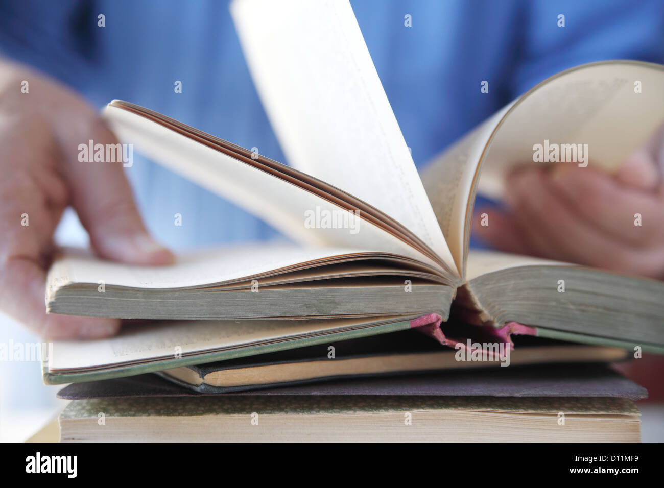 a man flips through the pages of a book Stock Photo - Alamy