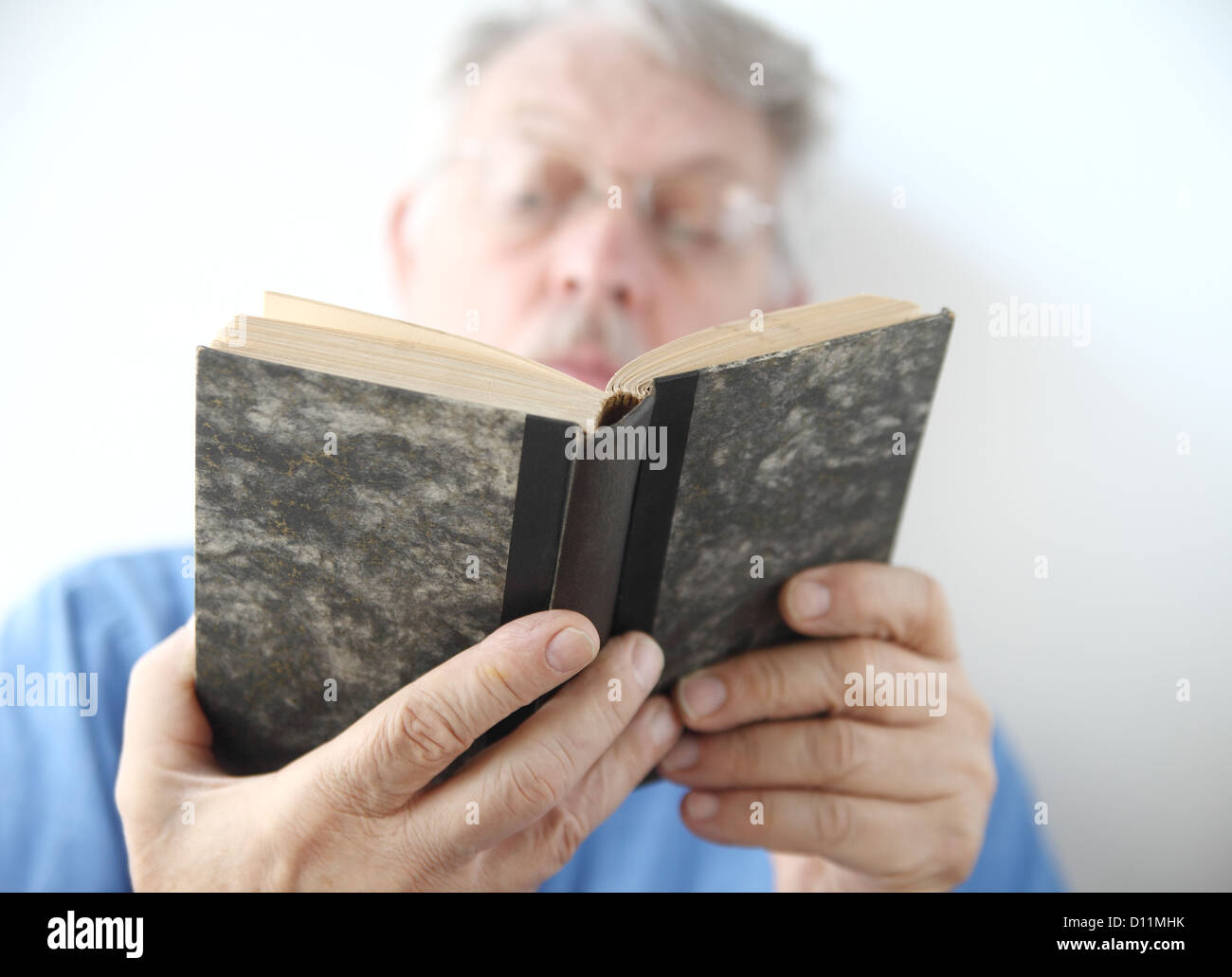 senior is reading an old book Stock Photo - Alamy