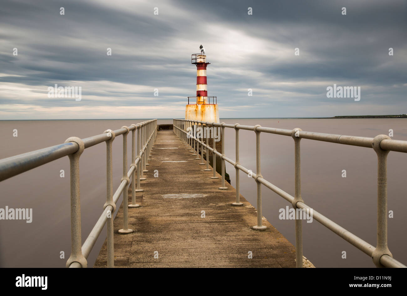 A Red And White Striped Lighthouse At The End Of A Pier; Amble ...