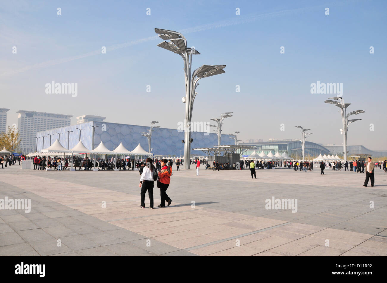 Pedestrians On A Walkway In An Urban Area With Unique Light Posts ...