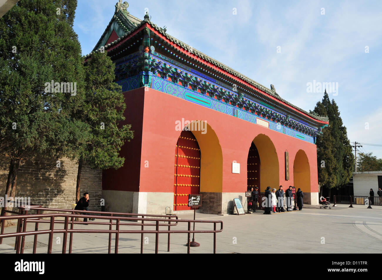 People Standing Outside A Colourful Building Of Traditional Chinese ...