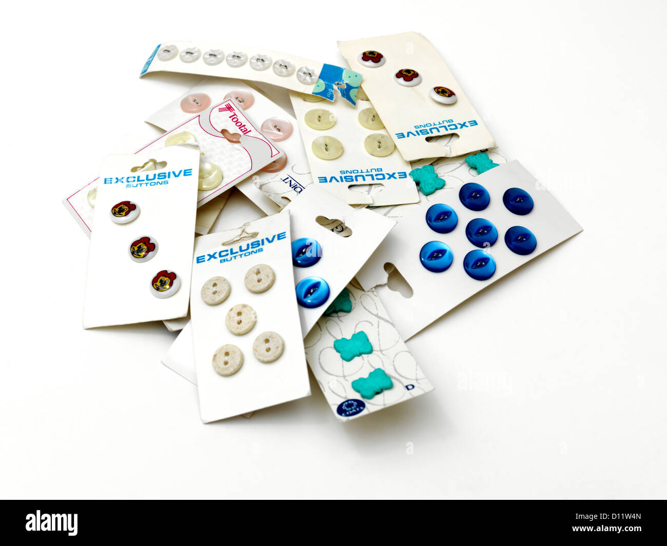 A Pile Of Buttons On Cardboard Stock Photo - Alamy